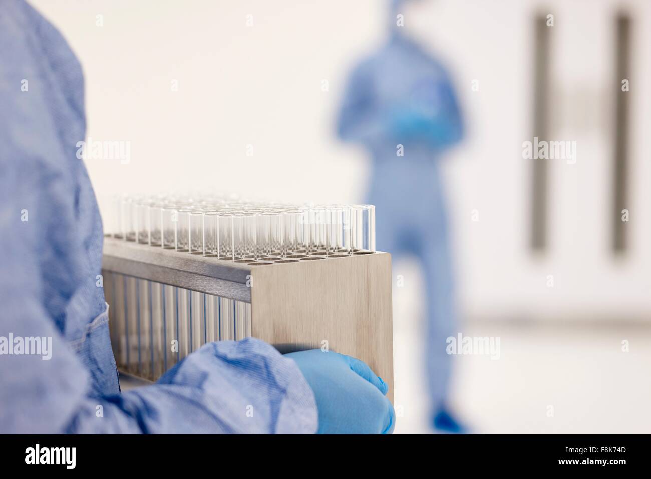 Scientist carrying tray of test tubes in laboratory Stock Photo - Alamy