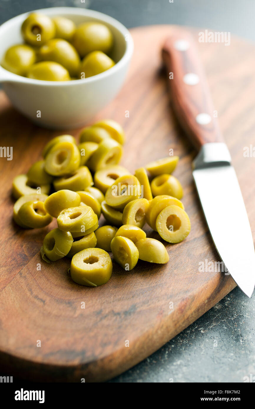 sliced green olives on cutting board Stock Photo - Alamy