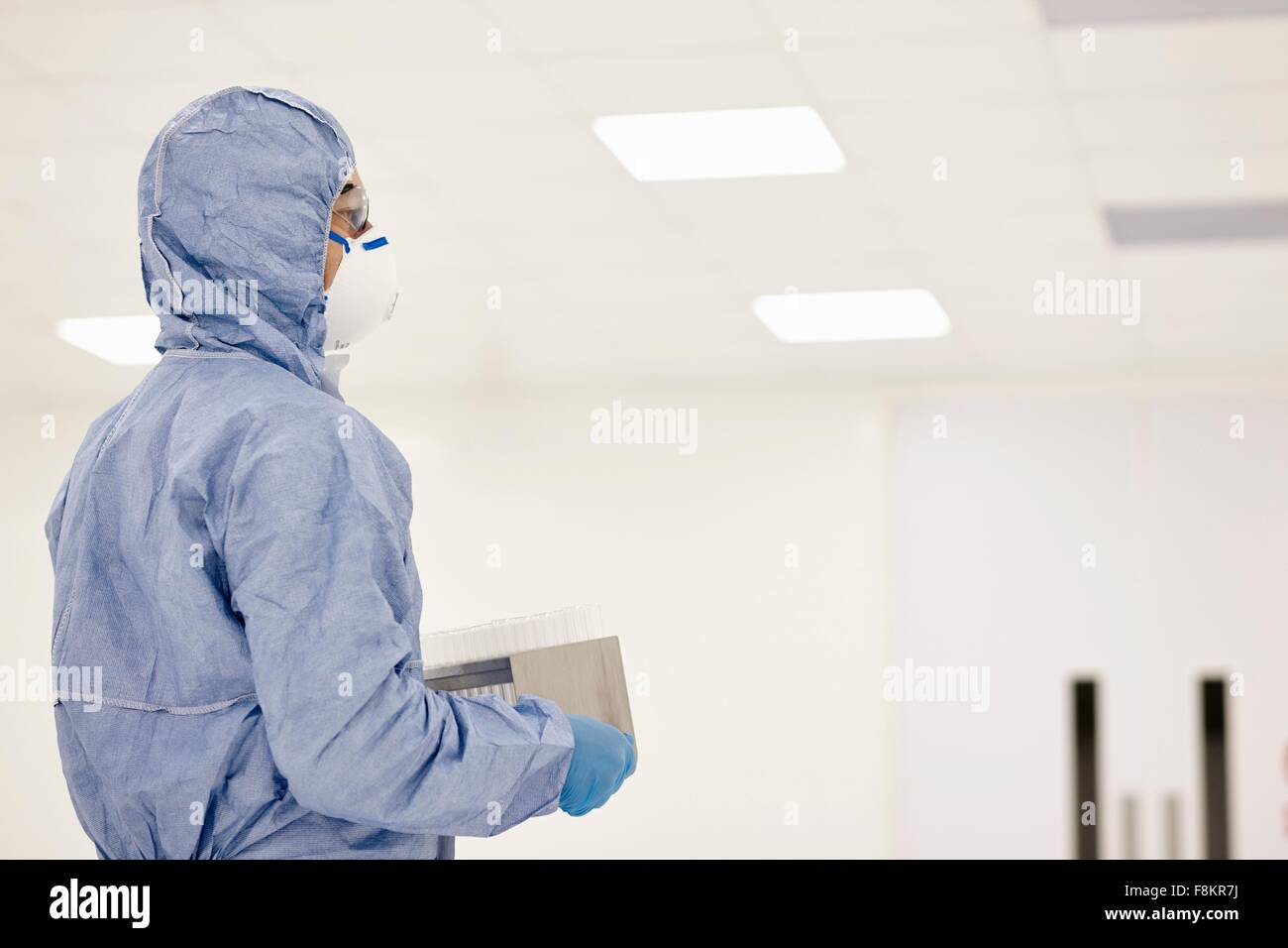 Scientist carrying tray of test tubes in laboratory Stock Photo - Alamy
