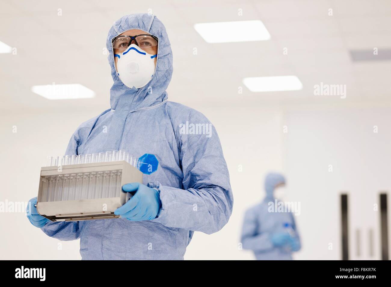 Scientist carrying tray of test tubes in laboratory Stock Photo - Alamy