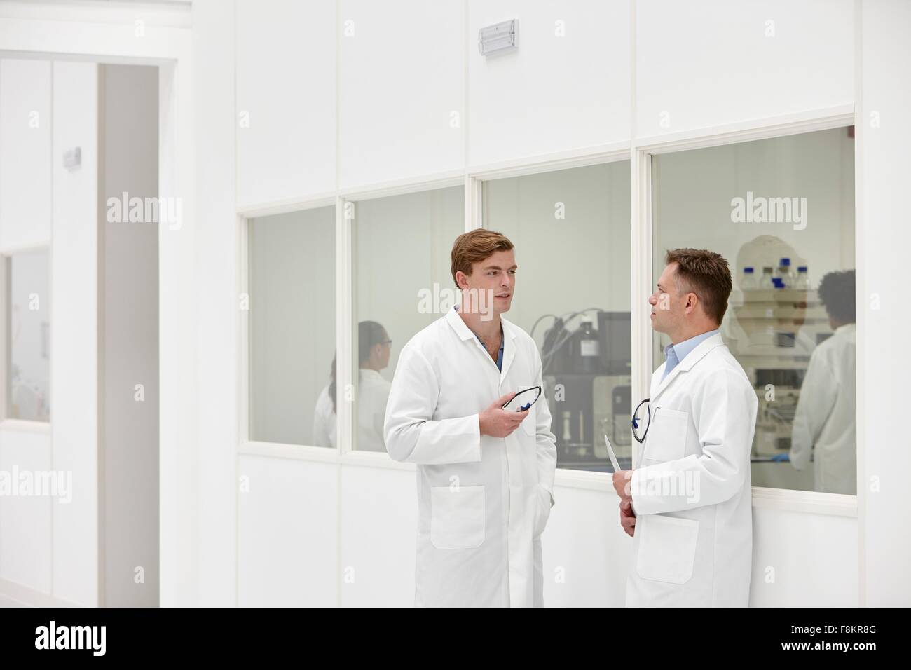 Scientists talking in laboratory Stock Photo - Alamy