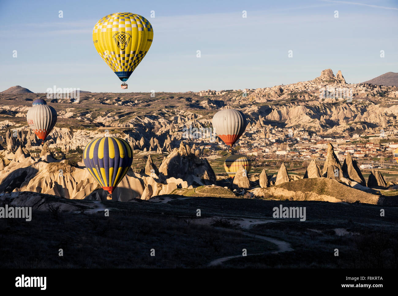 Hot air balloons flying among Rock formations at sunrise in the Red ...