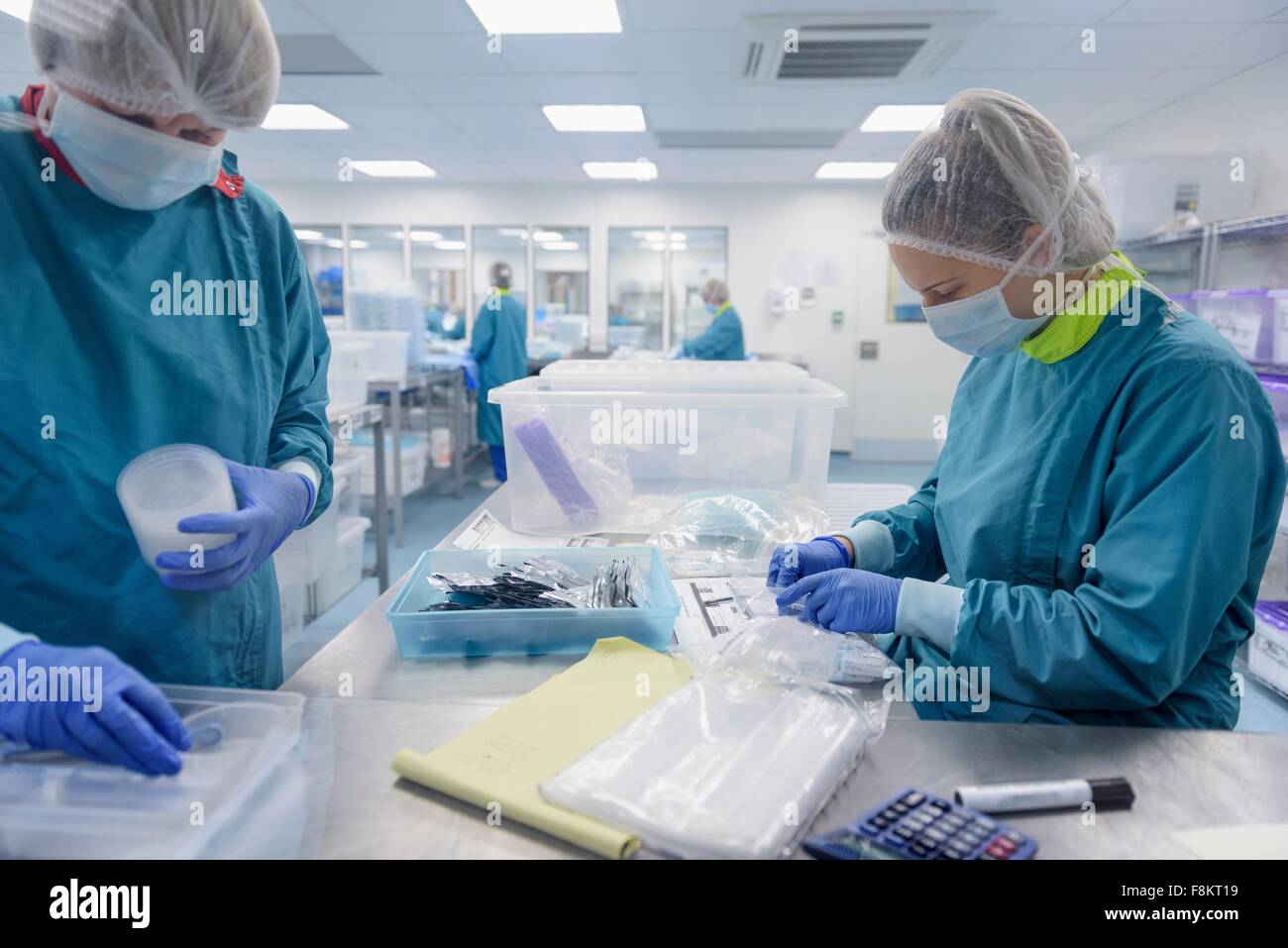 Workers packing surgical instruments in clean room of surgical ...