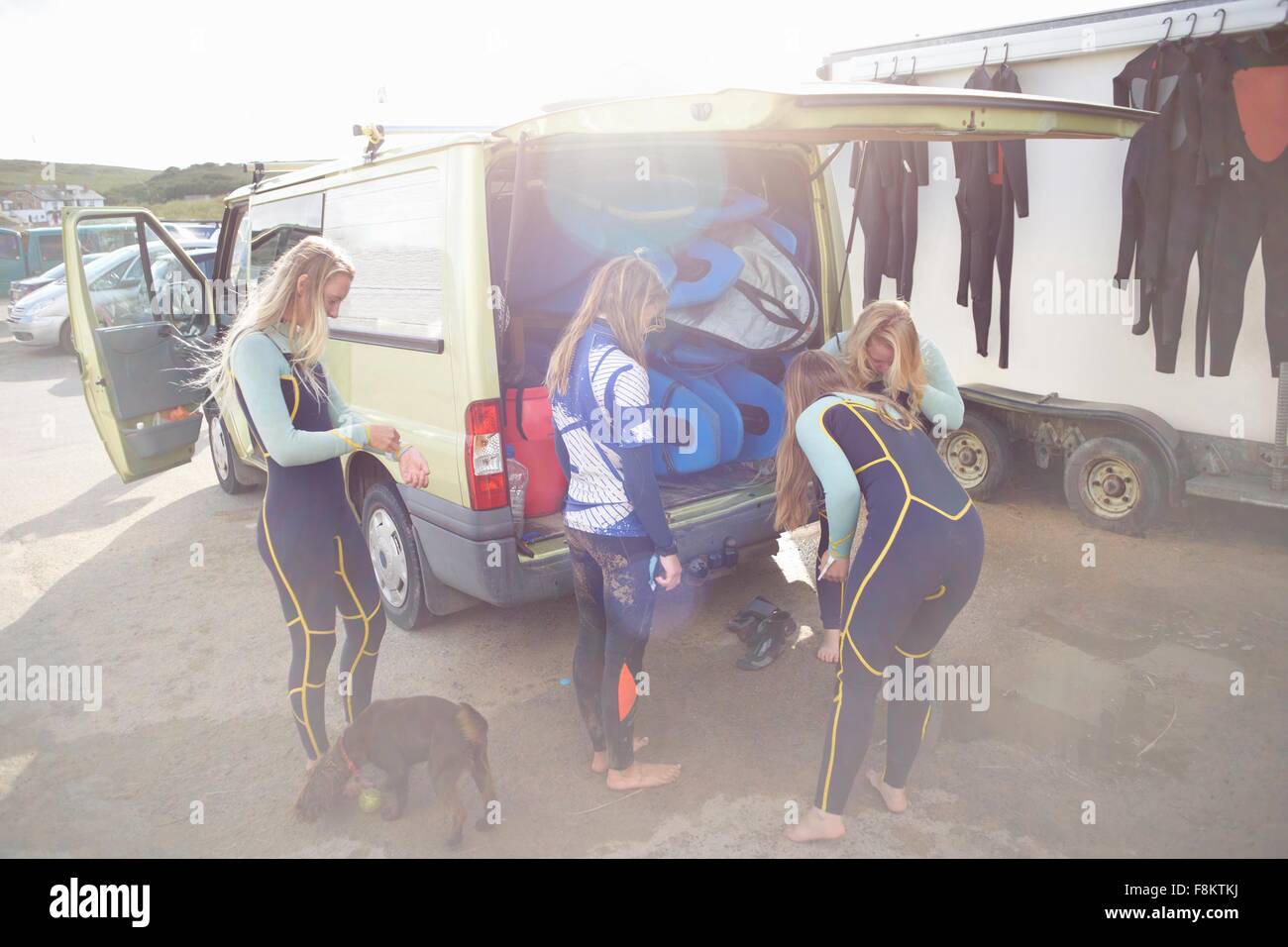Group of surfers getting ready to surf Stock Photo - Alamy