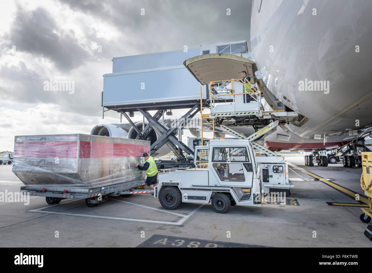 Ground crew loading freight into A380 aircraft Stock Photo - Alamy