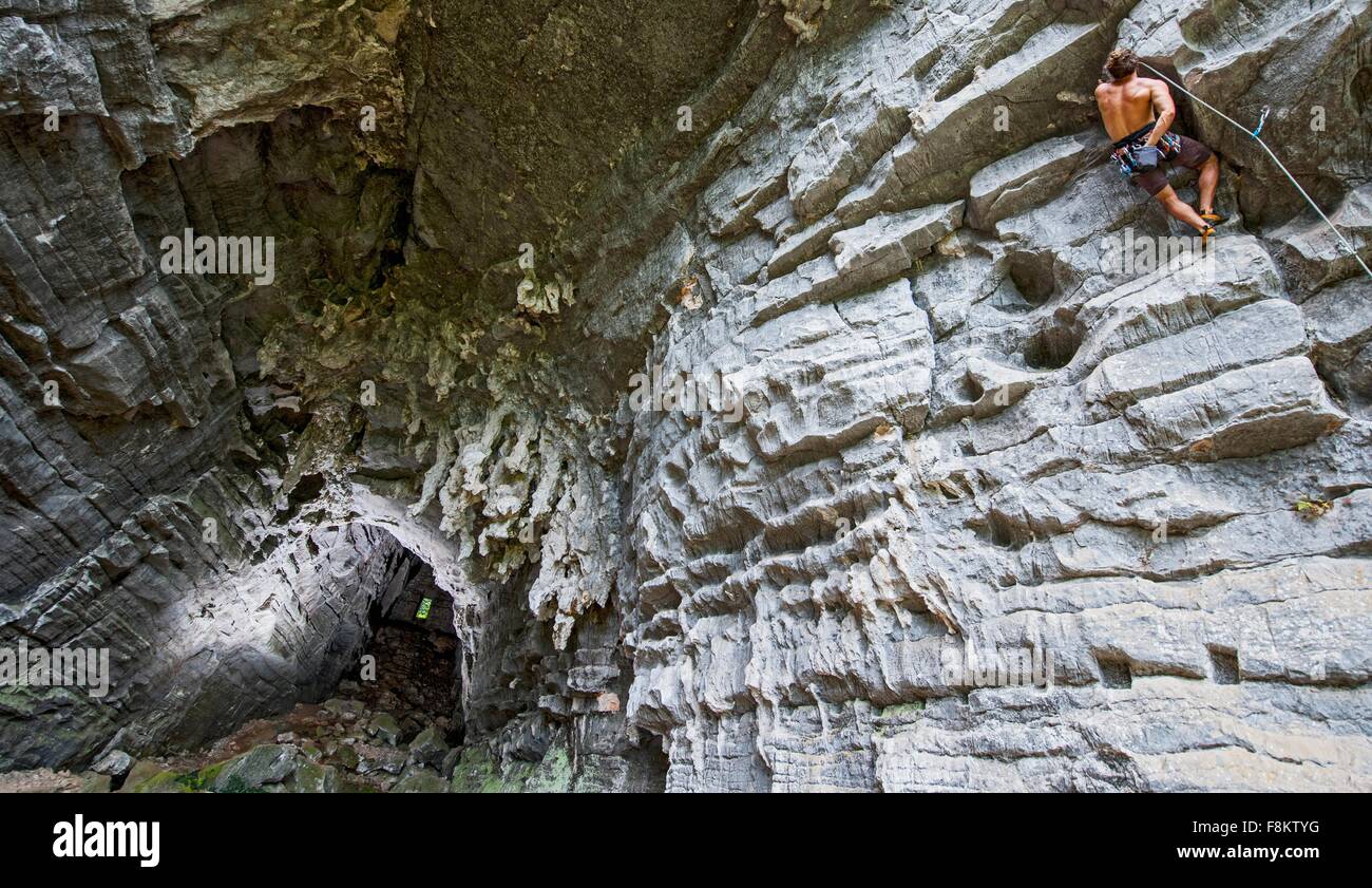 Male climber climbing treasure cave in Yangshuo, Guangxi Zhuang, China ...