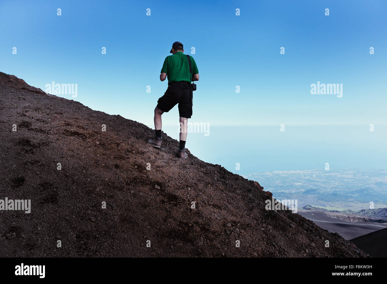 A tourist enjoying the landscape of Catania from Mount Etna Stock Photo ...