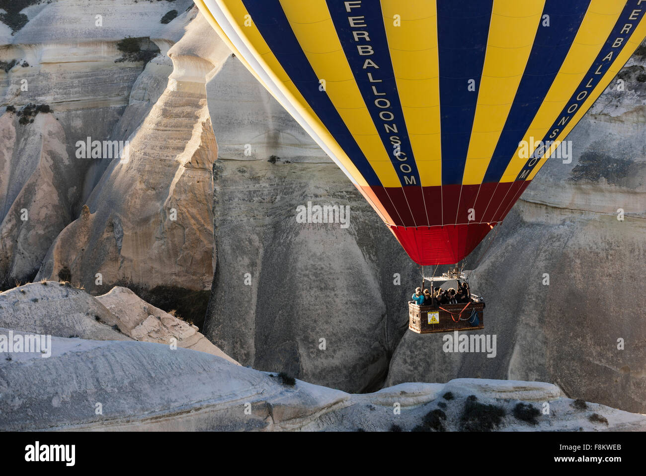 Hot air balloons flying among Rock formations at sunrise in the Red ...