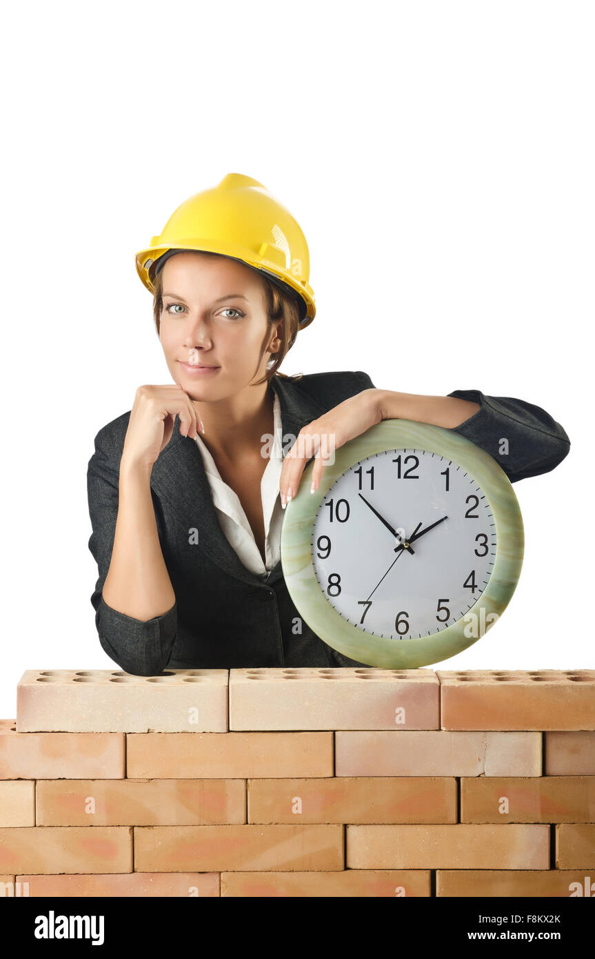 Female builder and clock on white Stock Photo - Alamy