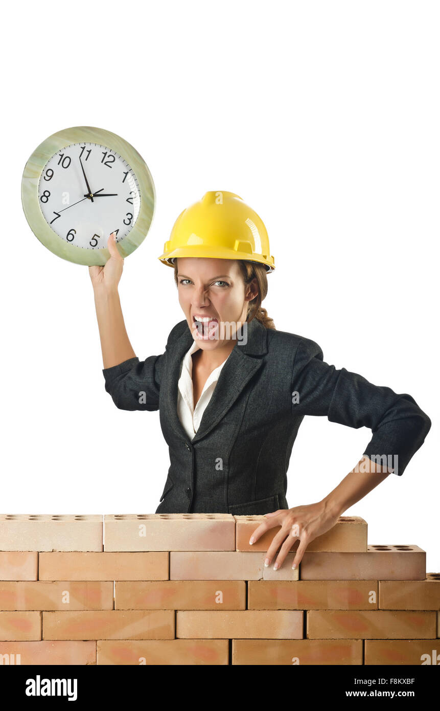 Female builder and clock on white Stock Photo - Alamy