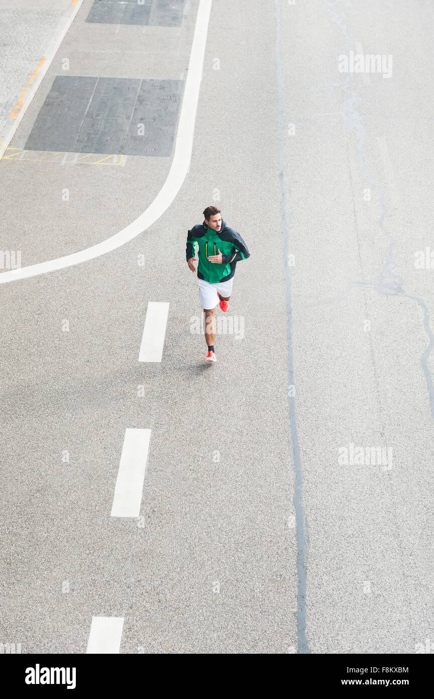 High angle view of young male runner running at parking lot Stock Photo ...