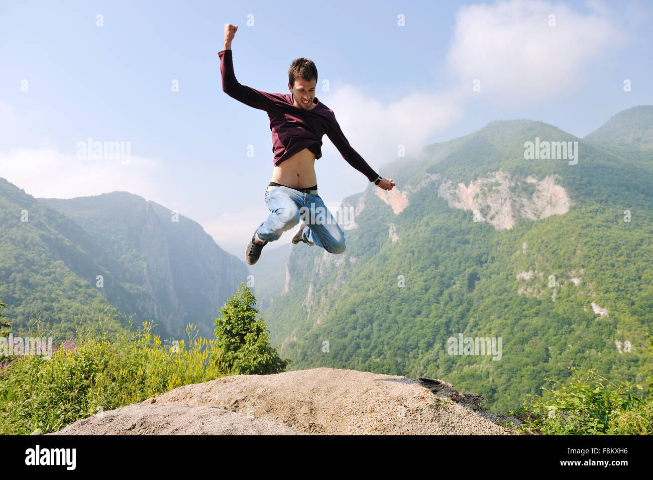happy young man jump in nature while representing healthy lifestyle ...