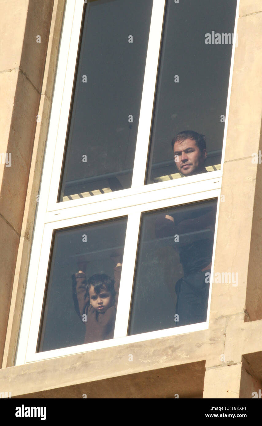 Gera, Germany. 10th Dec, 2015. Asylum seekers standing in the window at ...
