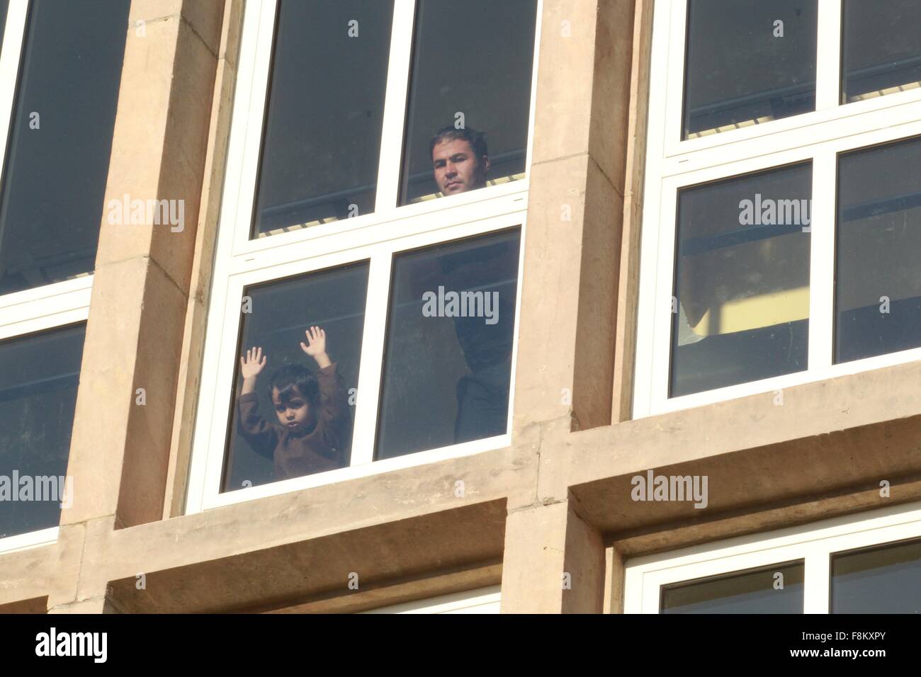 Gera, Germany. 10th Dec, 2015. Asylum seekers standing in the window at ...