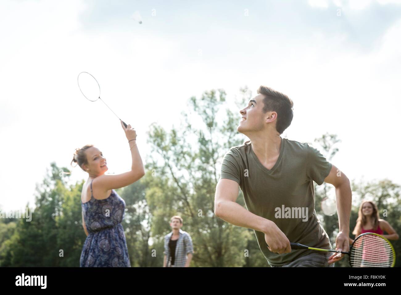 Group of young adults playing badminton in field Stock Photo - Alamy