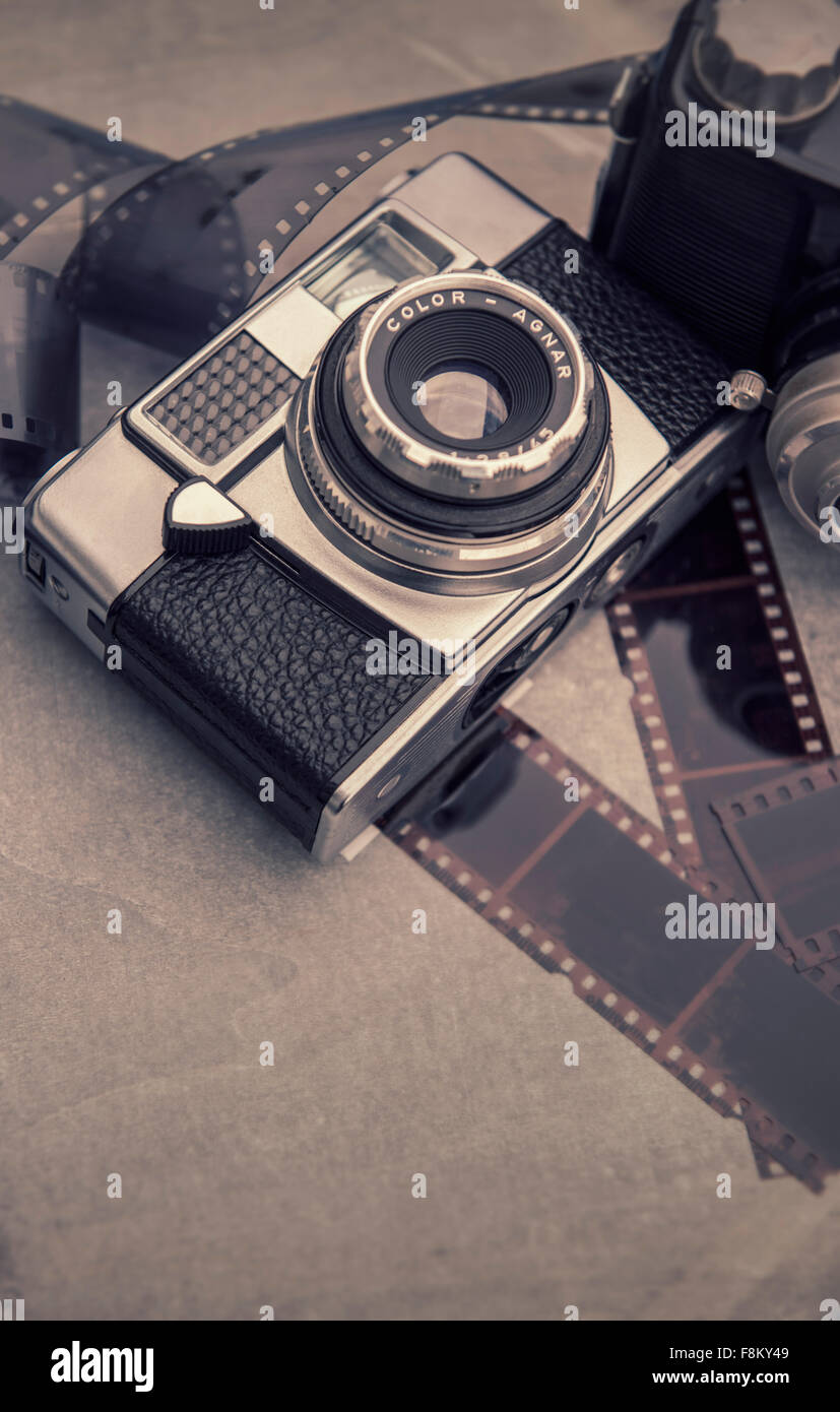 Retro cameras with roll of film and negatives Stock Photo - Alamy