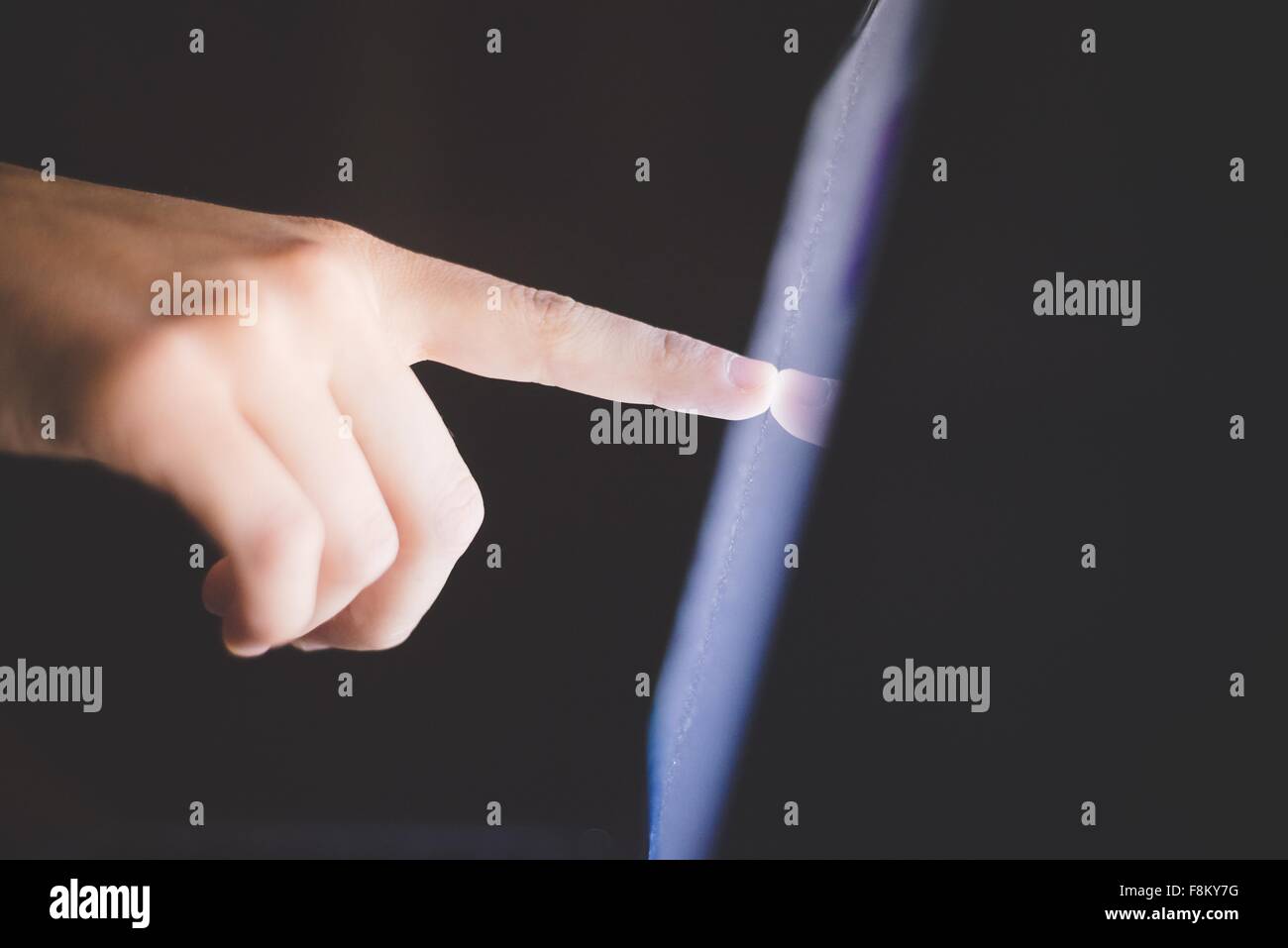 Side view of hand pointing at computer screen Stock Photo - Alamy