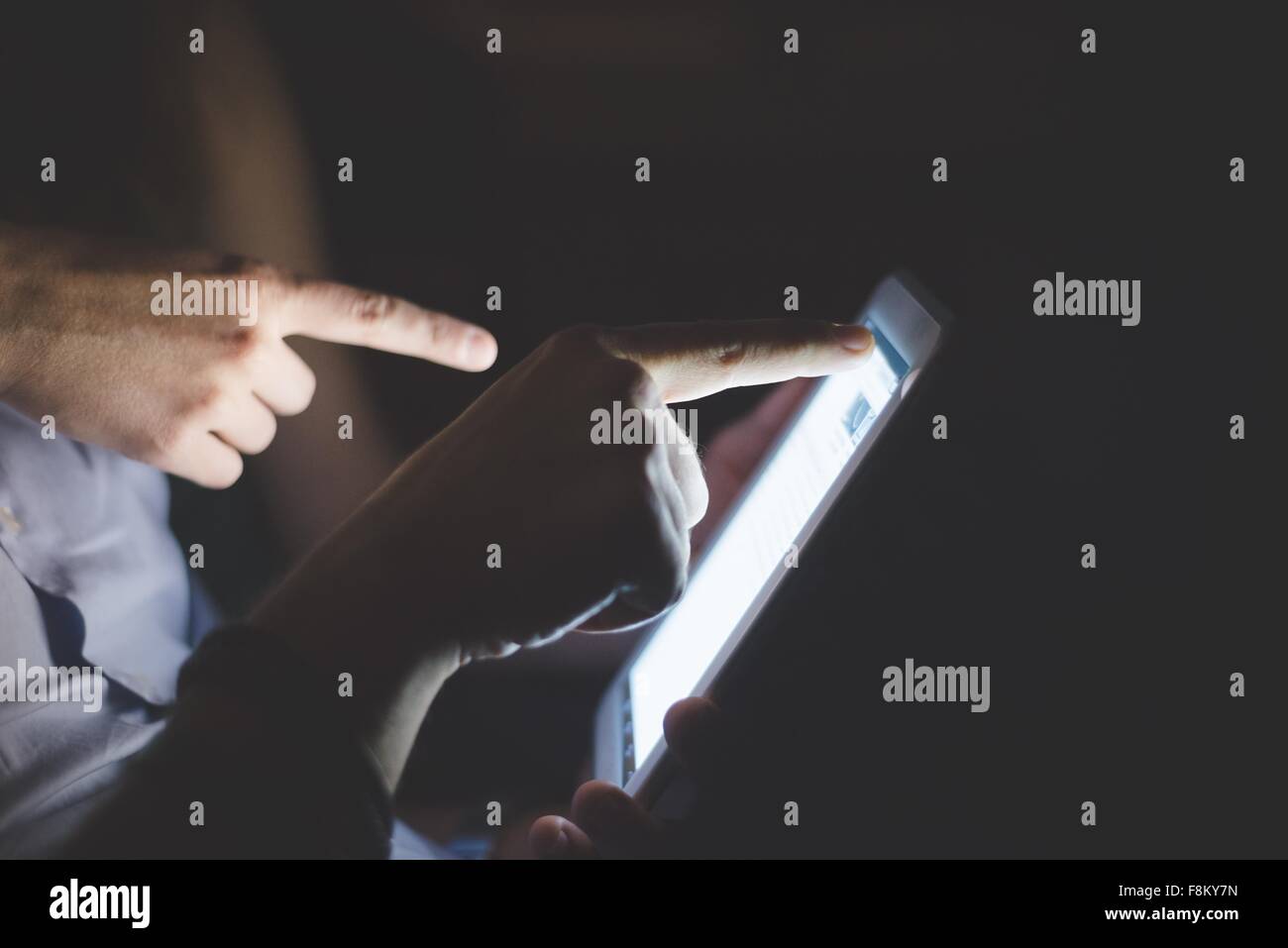 Side view of hands pointing at computer screen Stock Photo - Alamy