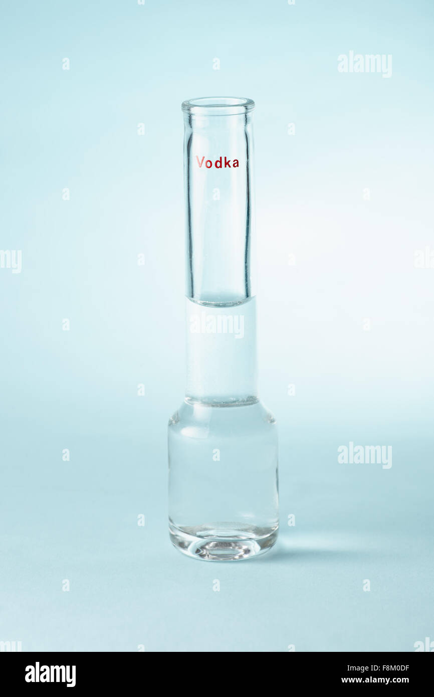Vodka glass on a blue background Stock Photo - Alamy
