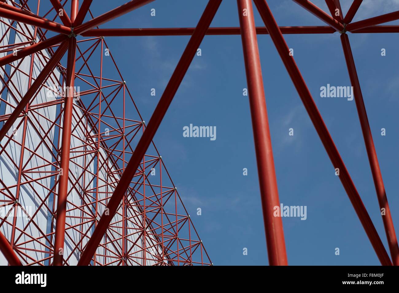Tall red framework structure with textile against blue sky Stock Photo ...