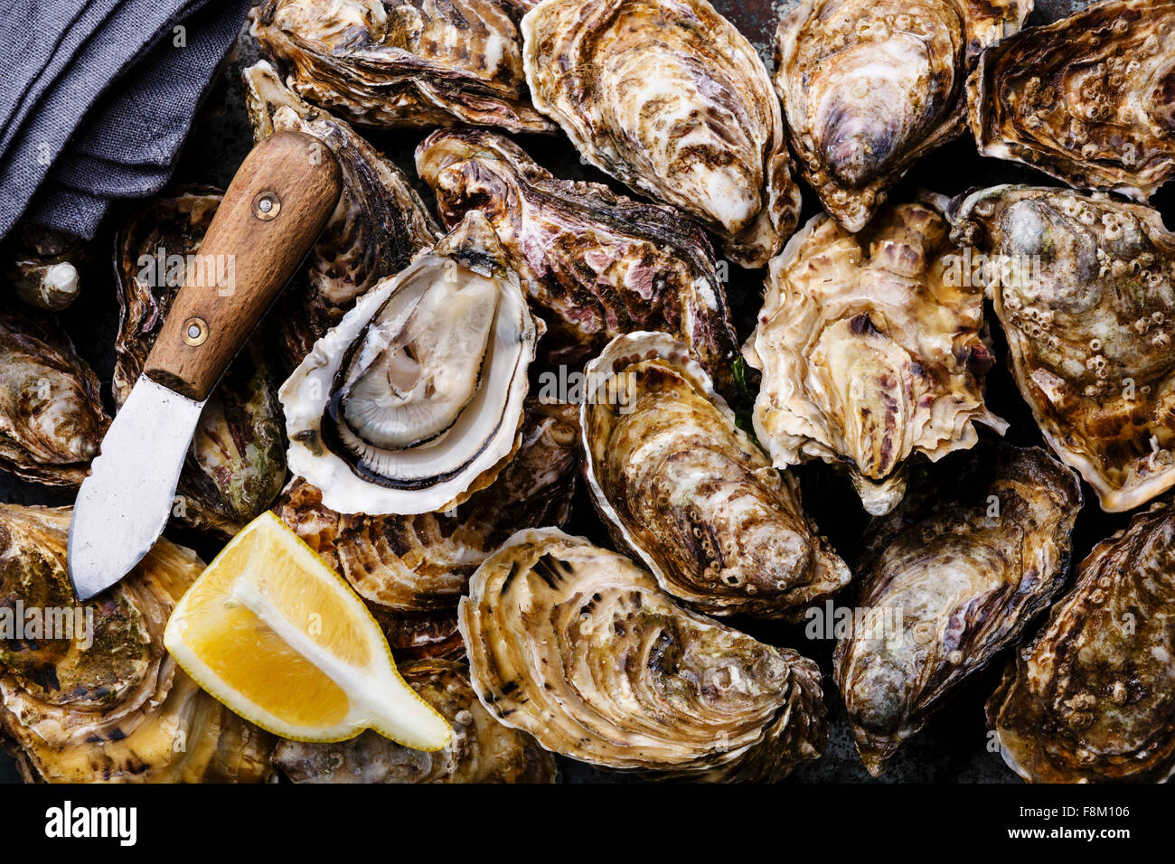 Oysters background with Open Oyster and knife Stock Photo - Alamy