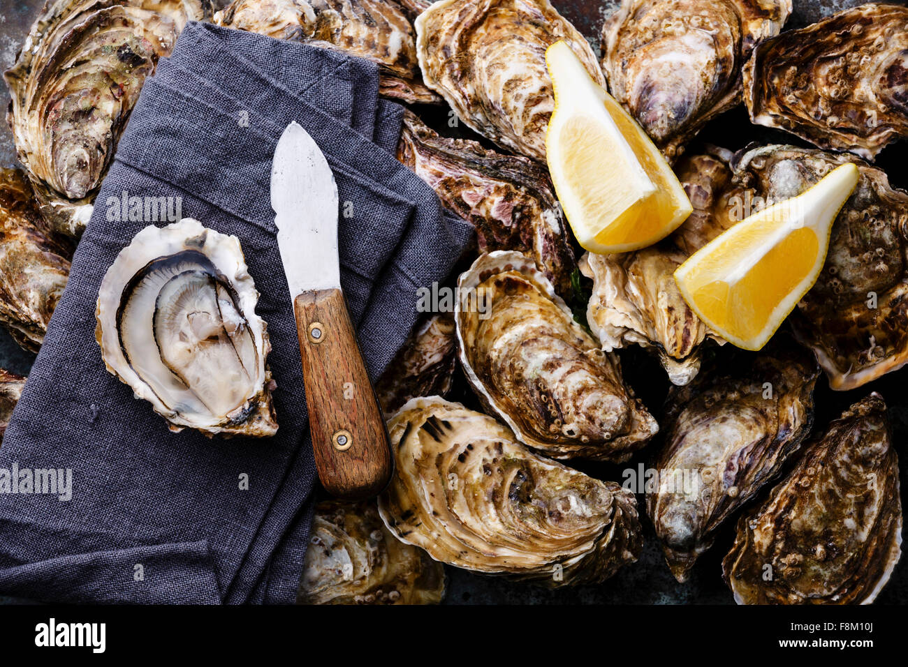 Oysters background with Open Oyster and knife Stock Photo - Alamy