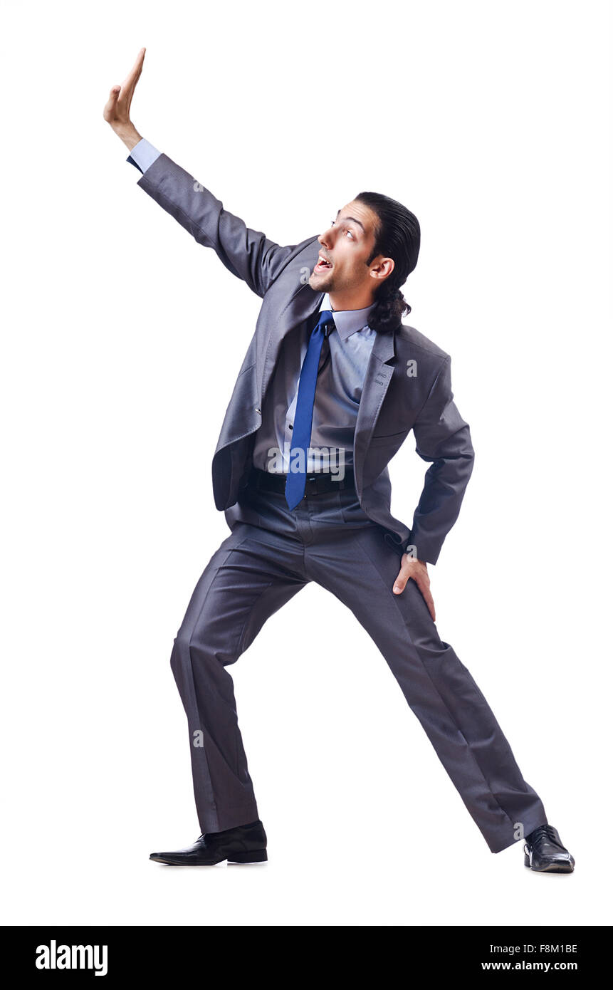 Young businessman pushing invisible obstacles Stock Photo - Alamy