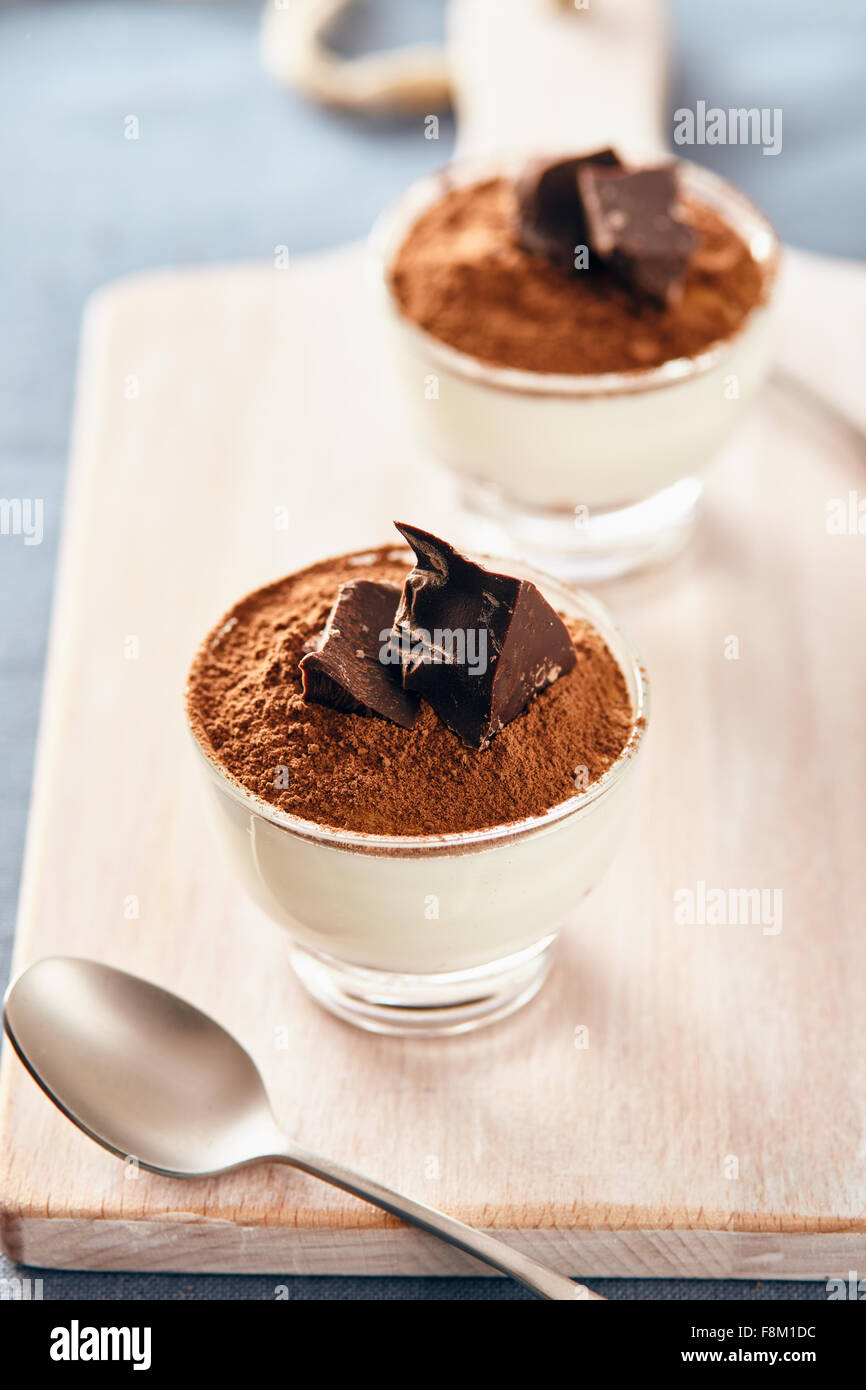Panna cotta with chocolate on a white chopping board, bright colors ...