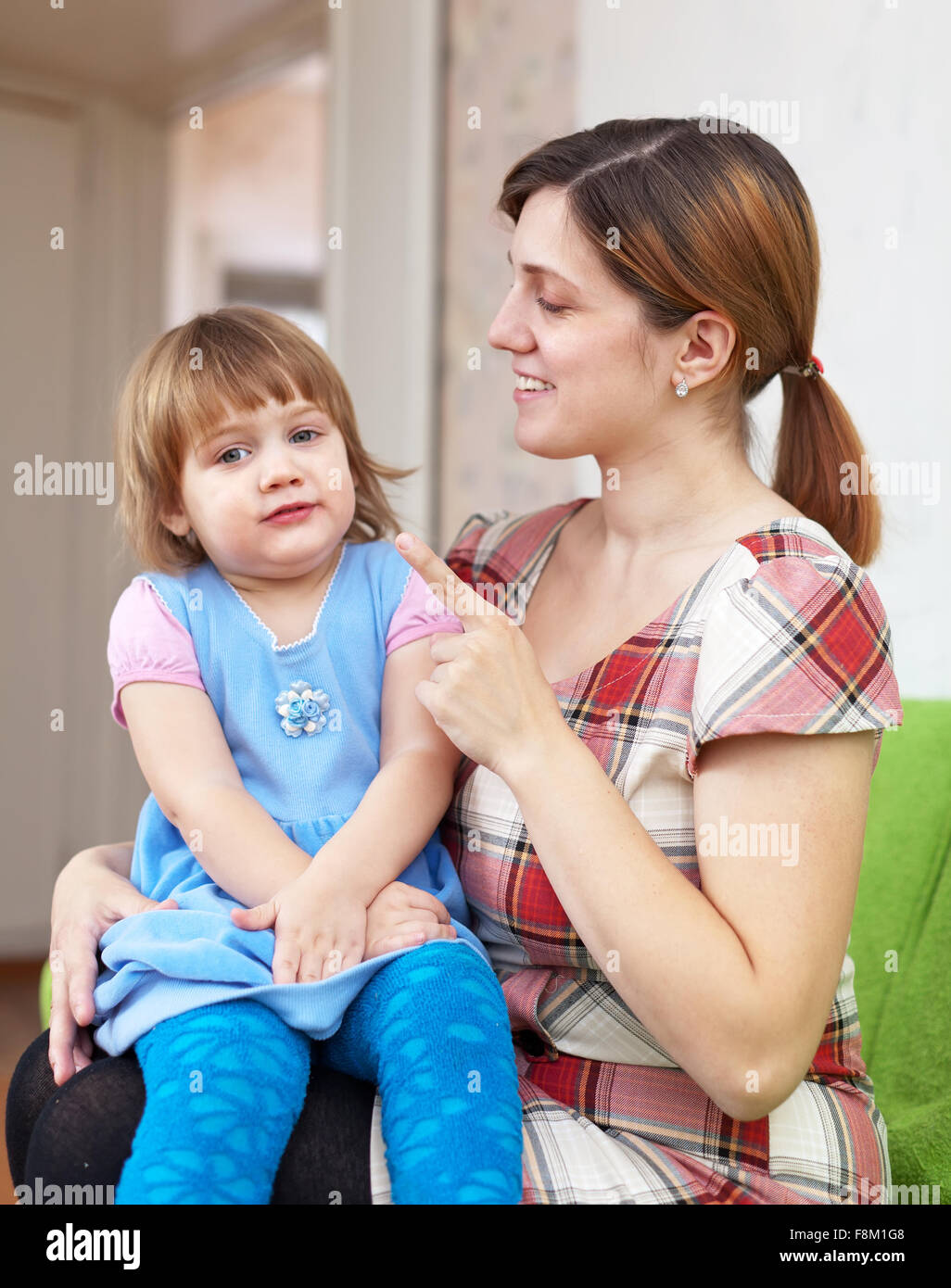Woman scolds her child in home interior Stock Photo - Alamy
