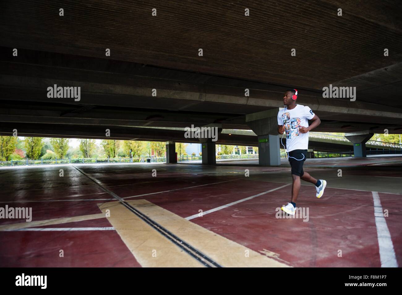 Young man running in urban environment Stock Photo - Alamy