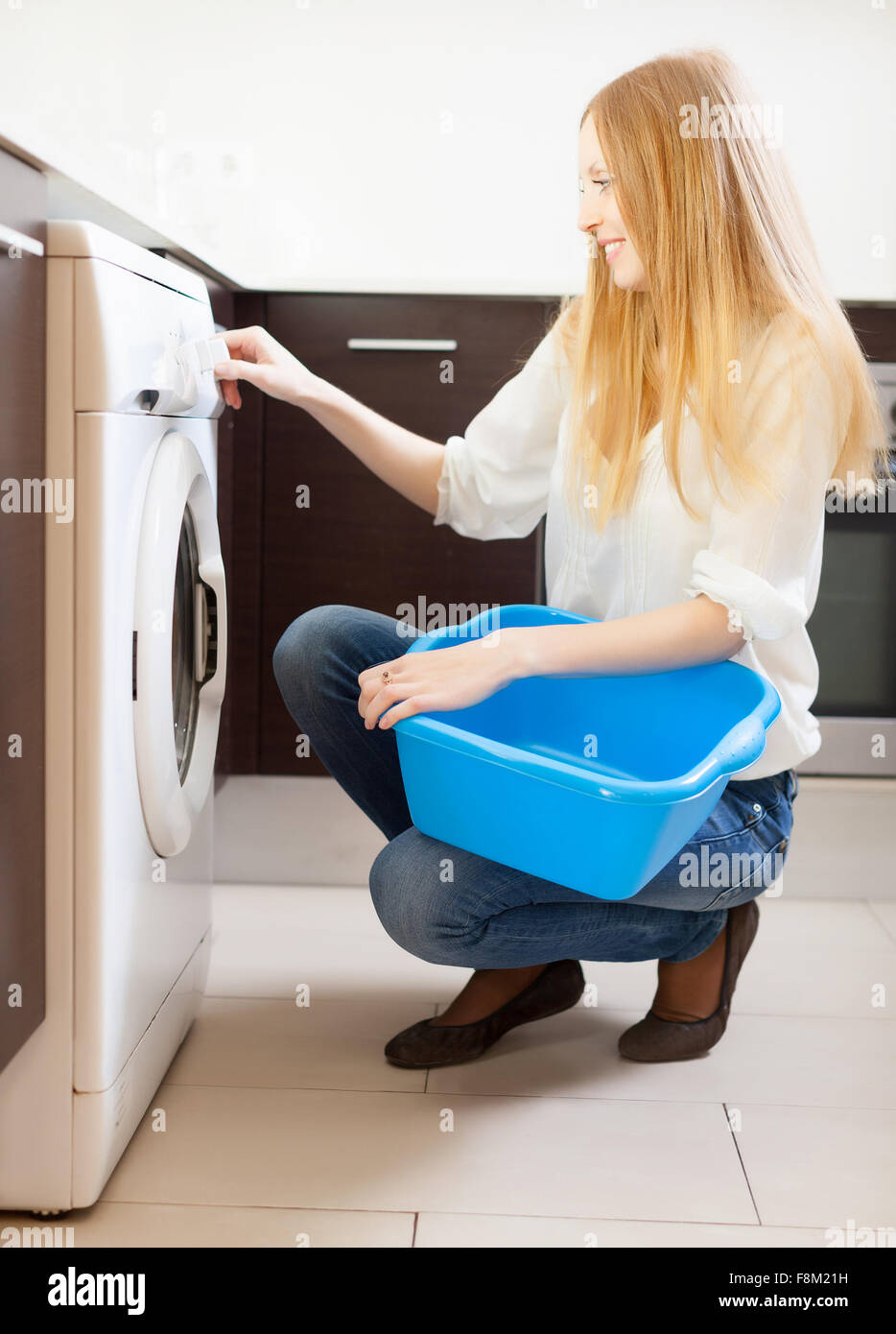 Long-haired woman with washing machine at home Stock Photo - Alamy
