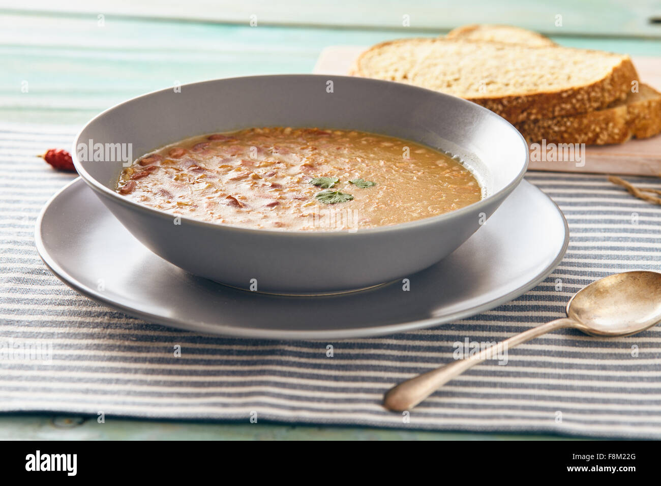 bean and spelt soup on a wooden table, bright colors Stock Photo - Alamy