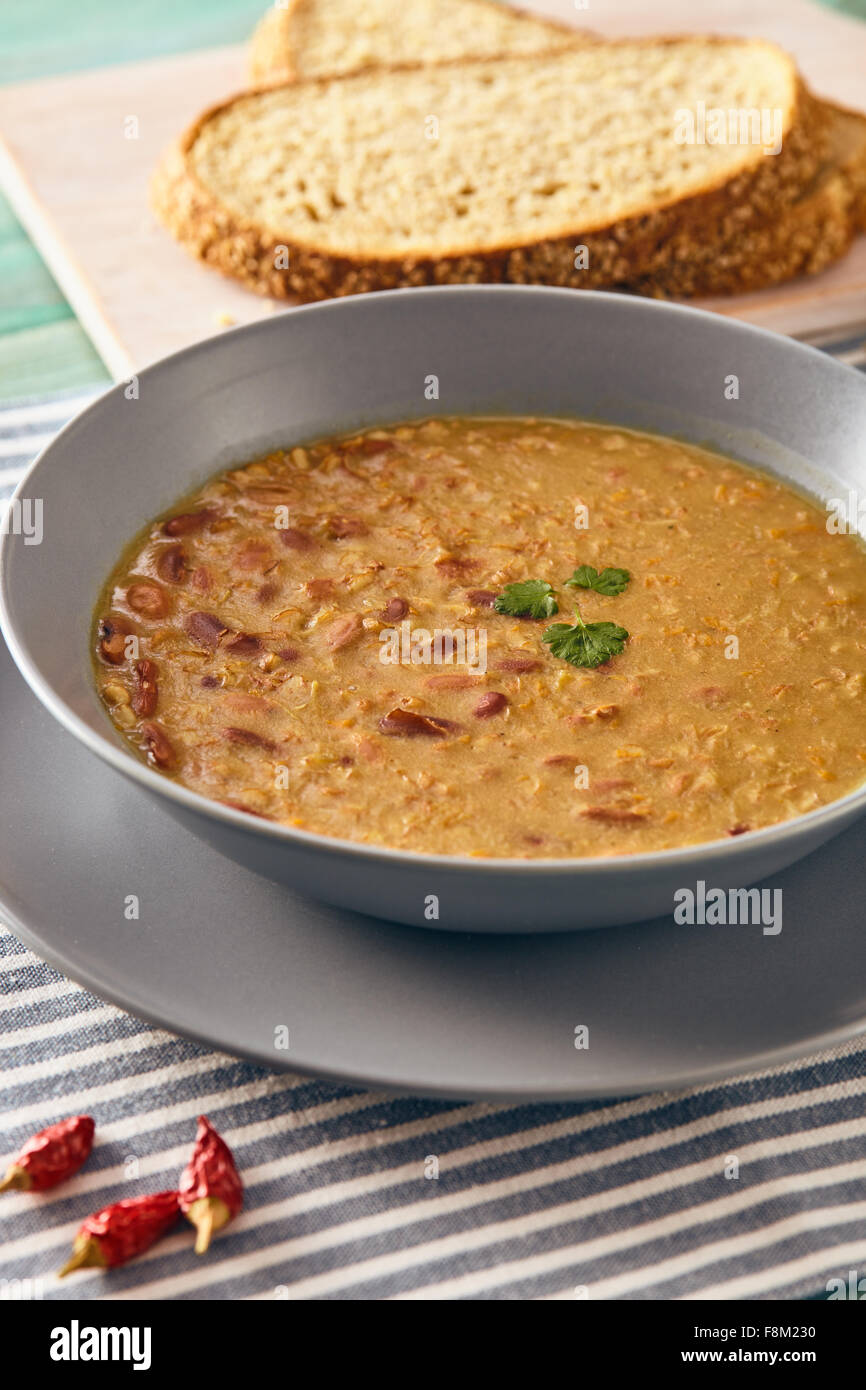 bean and spelt soup on a wooden table, bright colors Stock Photo - Alamy
