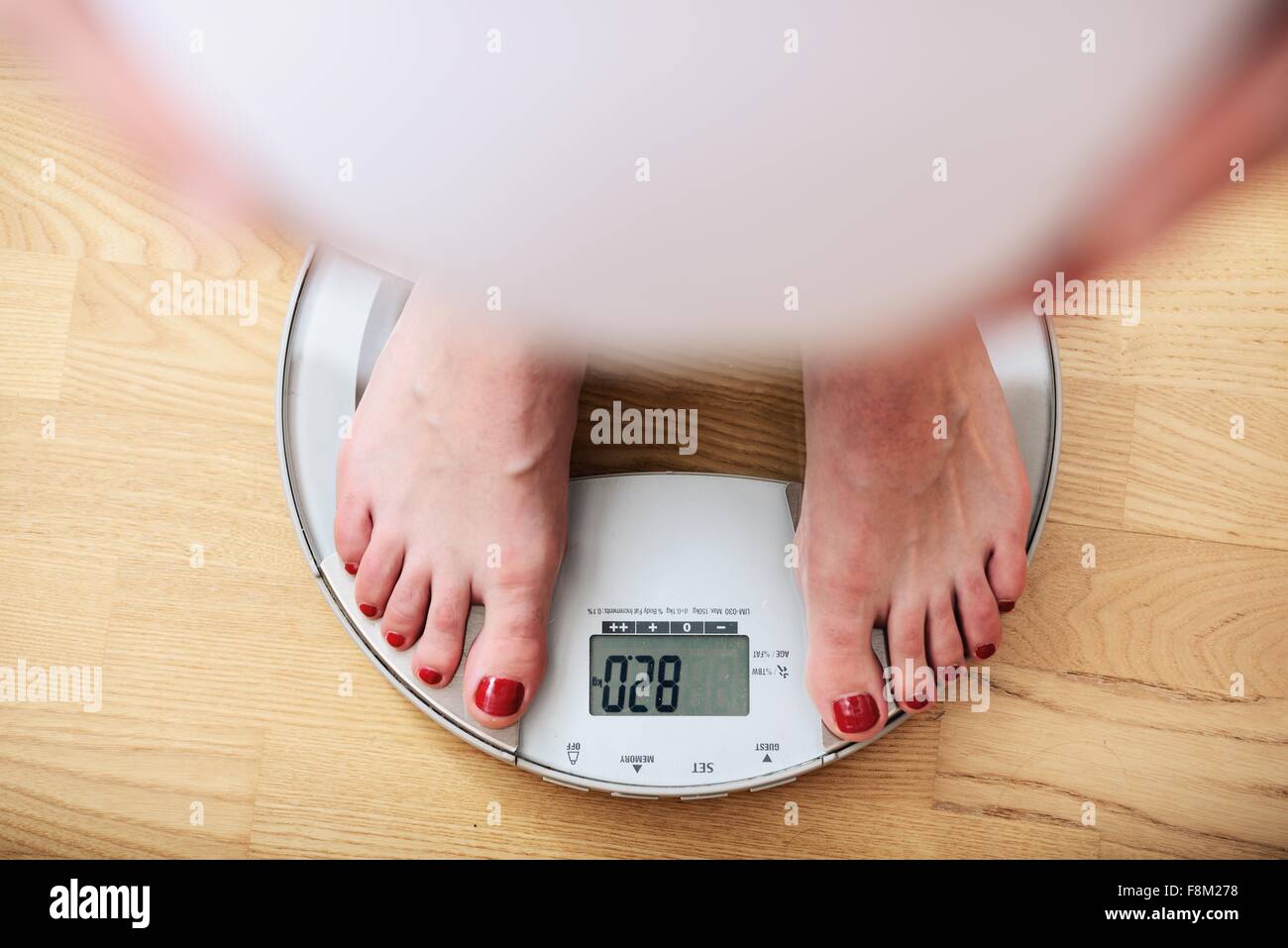 Pregnant woman standing on scales, overhead view Stock Photo - Alamy