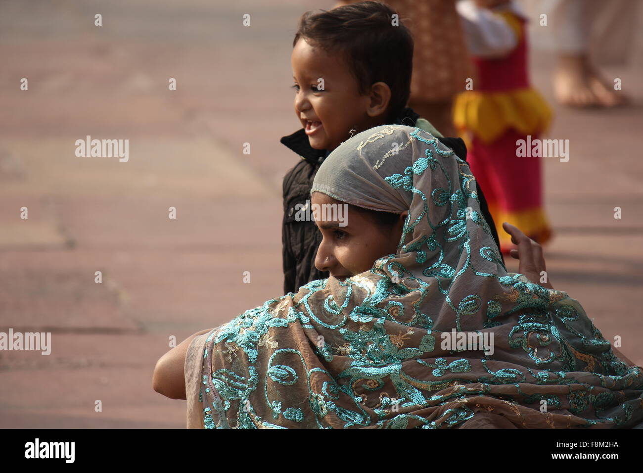 DELHI, INDIA - NOV 25: Indian girl from the backside, sit on the floor ...