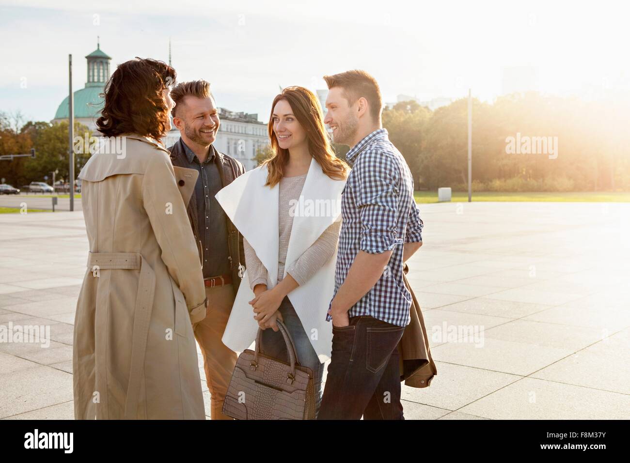 Friends meeting in town square Stock Photo - Alamy