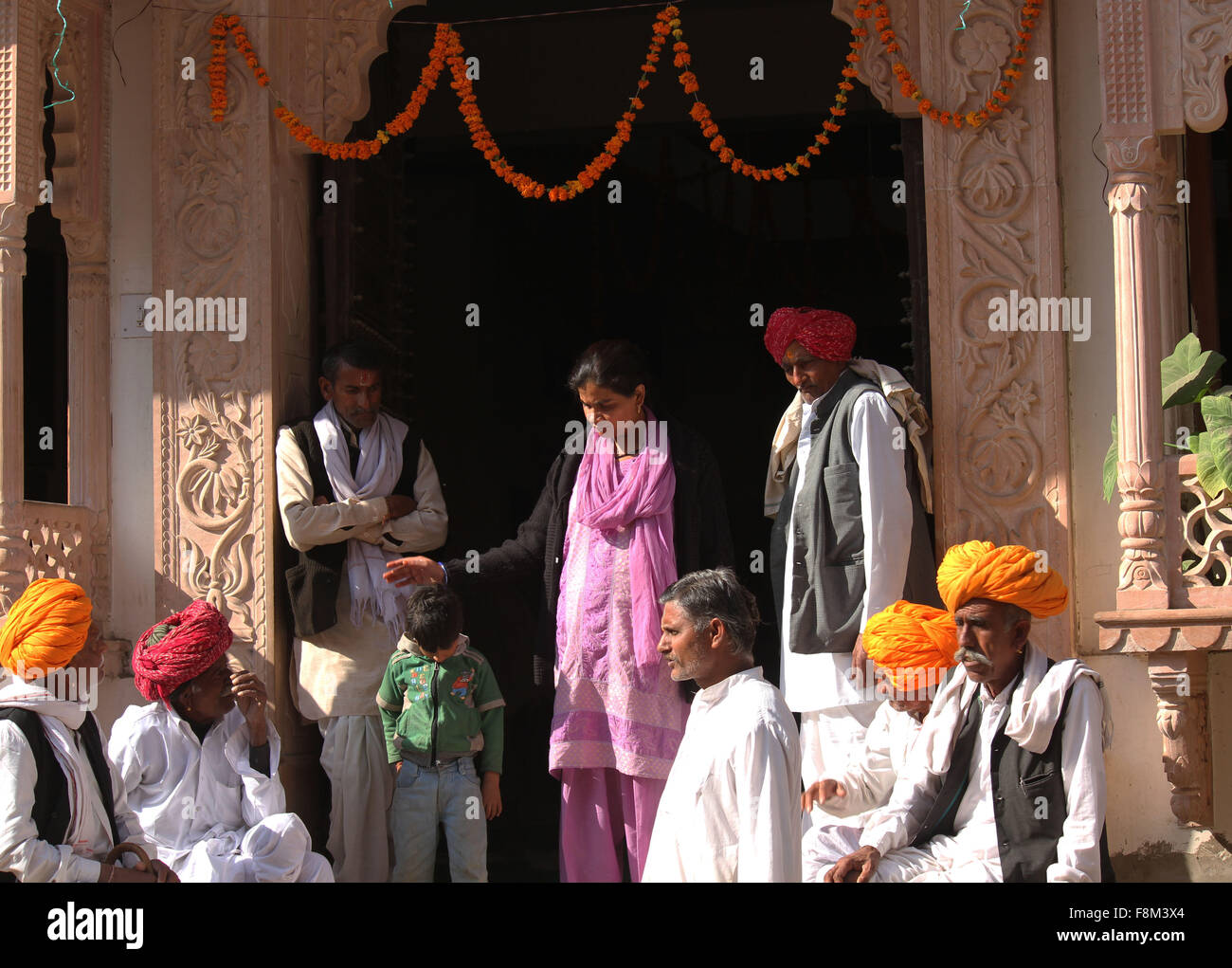 PUSHKAR, INDIA - NOV 28 2012: Indian family outside a temple in India ...