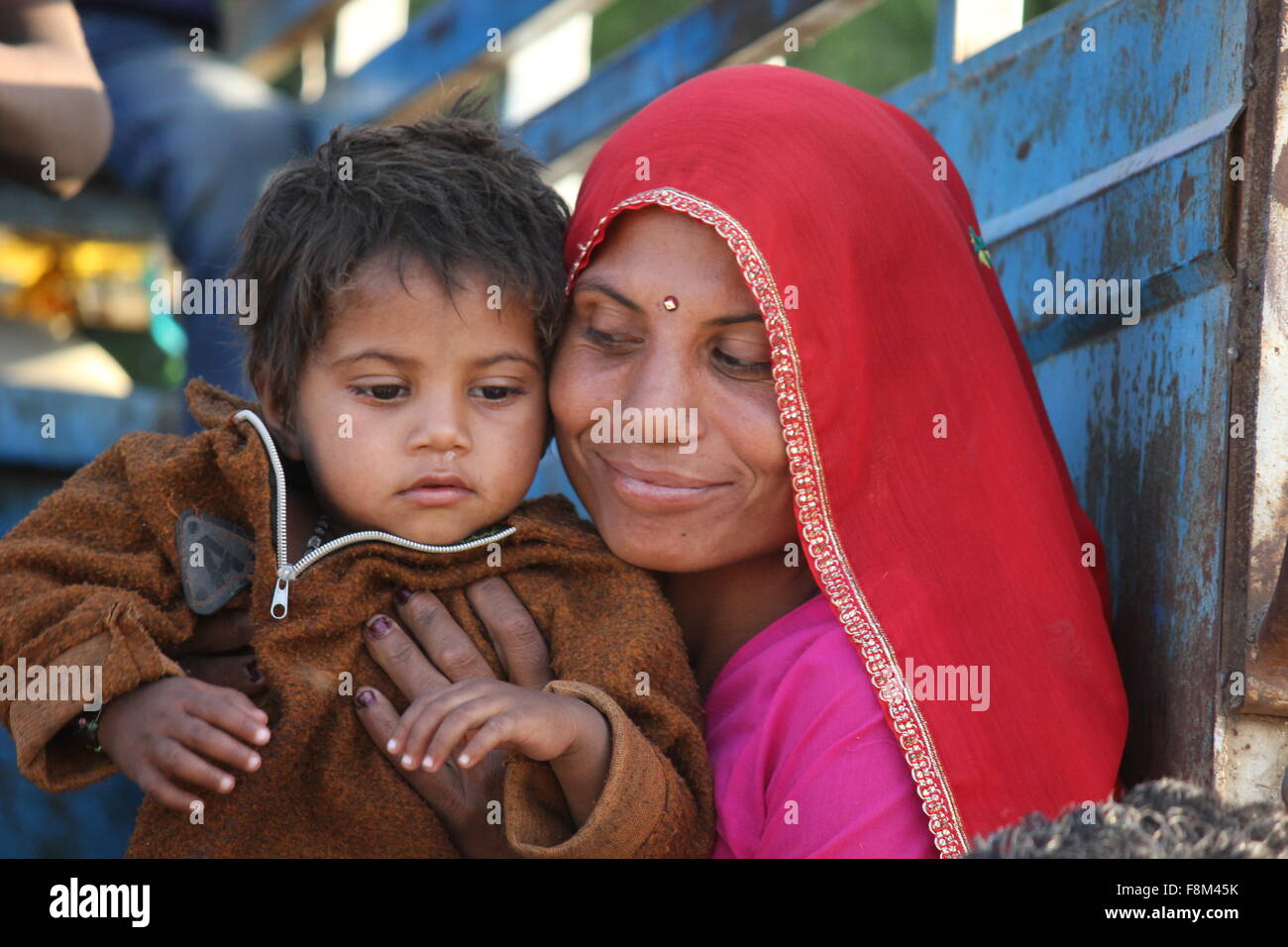 Pushkar, India, November 28 2012: A beautiful Indian Mum with her son ...