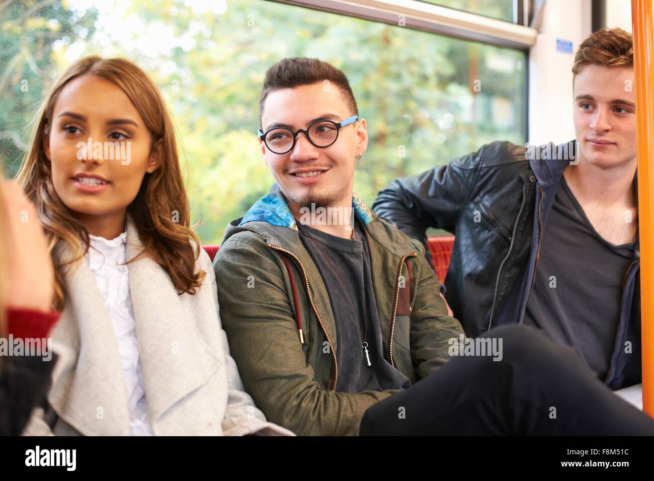 Group of young friends on train journey Stock Photo - Alamy