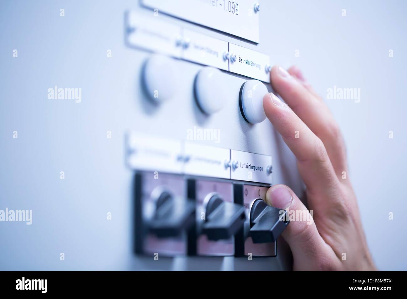 Cropped view of young mans hand adjusting dial on switchgear Stock ...