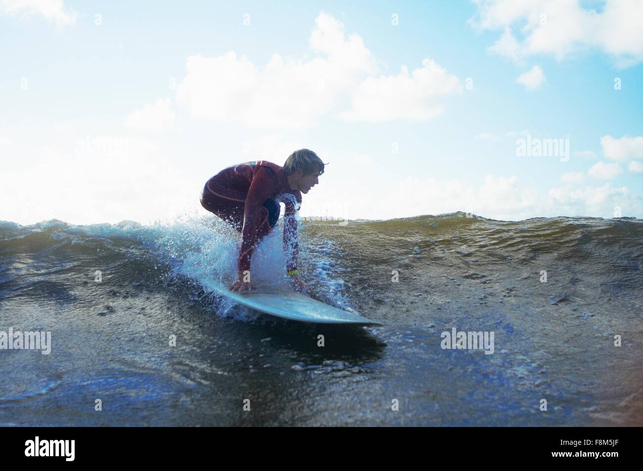 Male surfer riding wave Stock Photo - Alamy