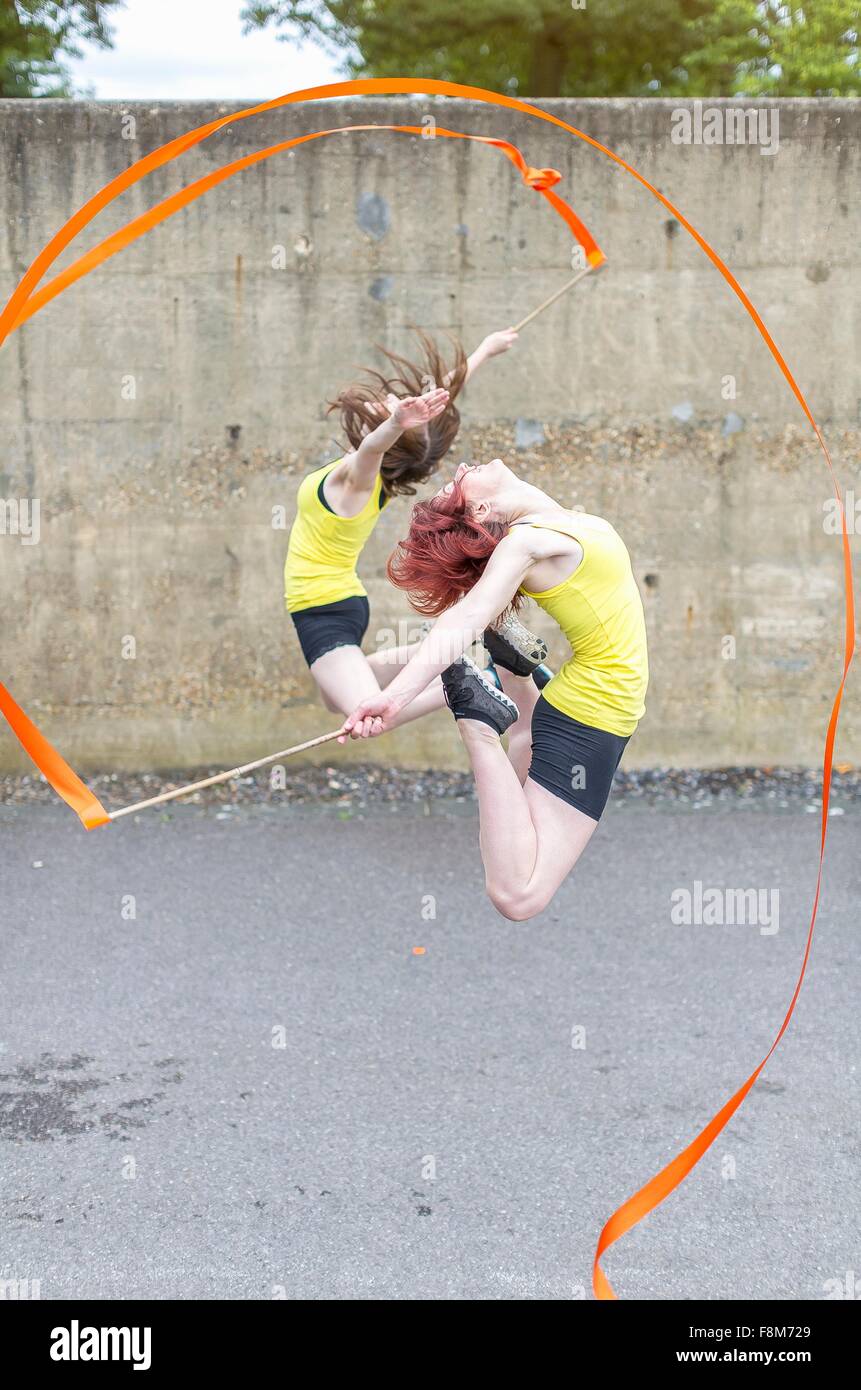 Young women practising ribbon dance on court Stock Photo - Alamy