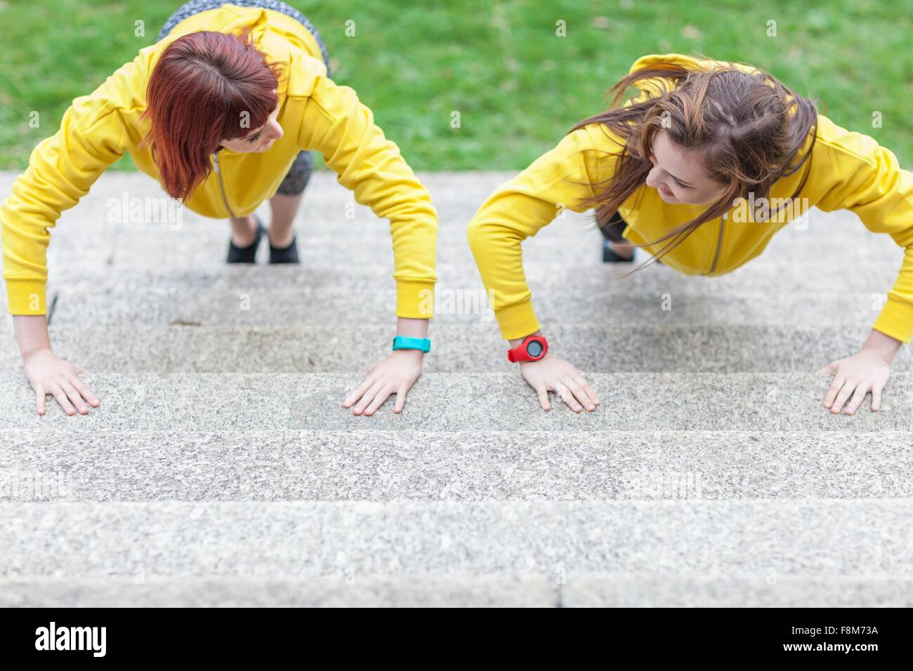 Young women doing push-ups on steps Stock Photo - Alamy