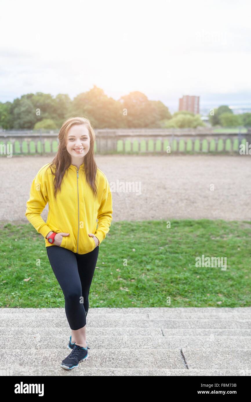 Young woman standing on steps Stock Photo - Alamy