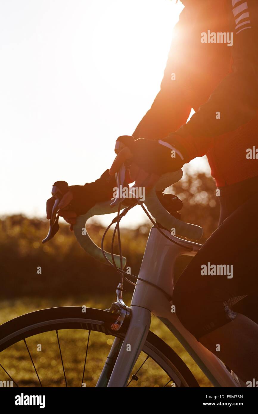 Cyclist riding during sunset Stock Photo - Alamy