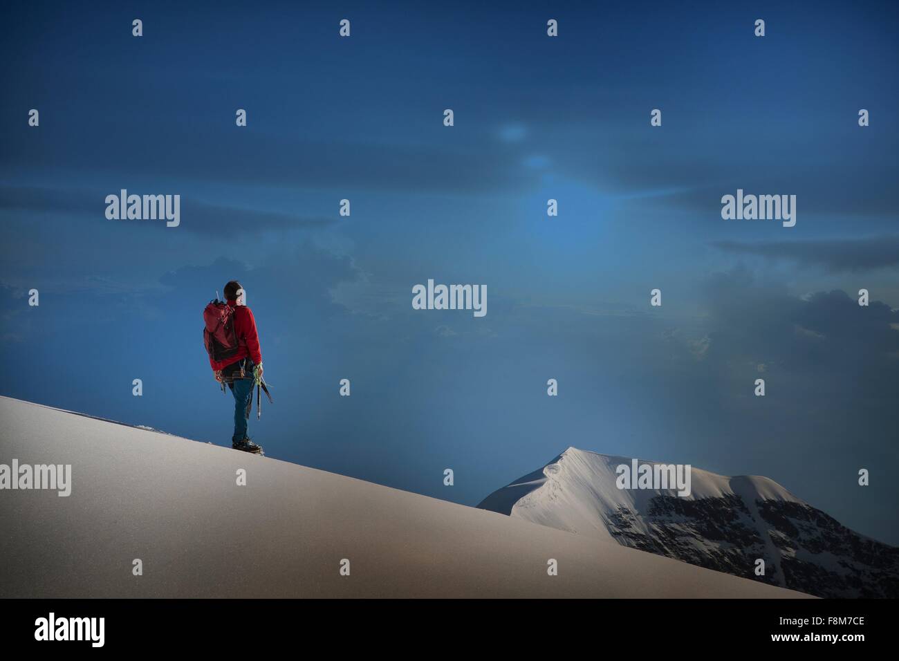 Male climber standing on ridge looking out, Canton Bern, Switzerland ...