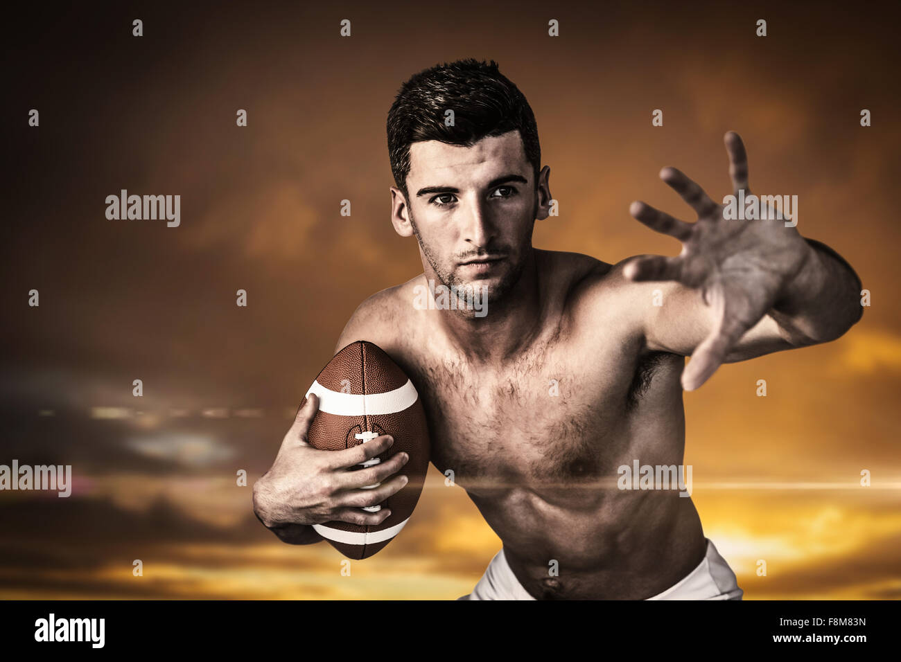 Composite image of shirtless rugby player defending Stock Photo - Alamy