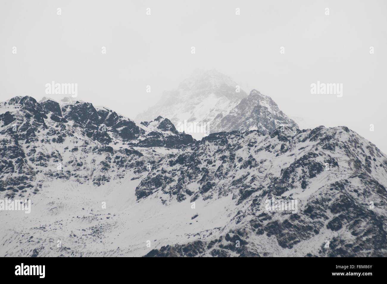 Snow capped misty mountain range, Nepal Stock Photo - Alamy
