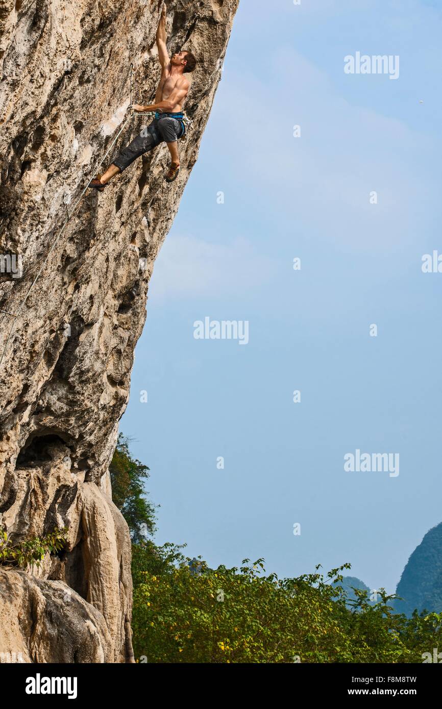 Low angle view of male climber climbing at white Mountain - a limestone ...