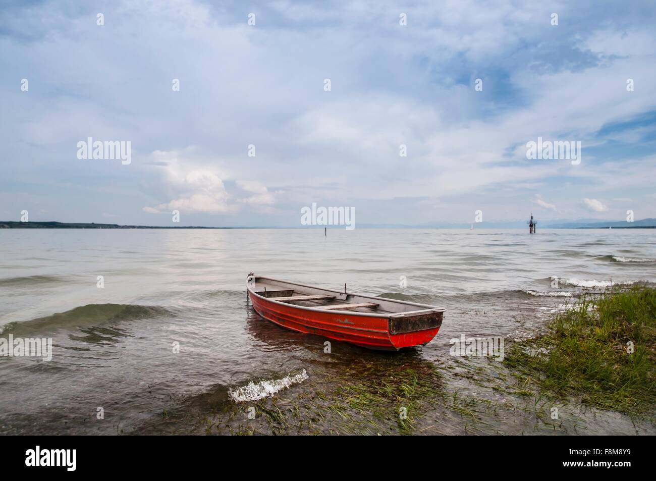 Red rowing boat at waters edge, Munich, Germany Stock Photo - Alamy